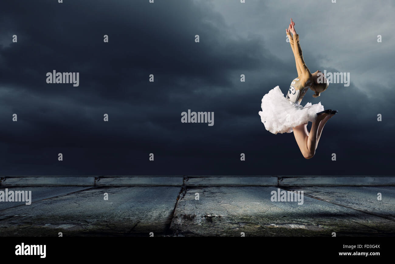 Young pretty ballerina girl making jump in dance Stock Photo - Alamy