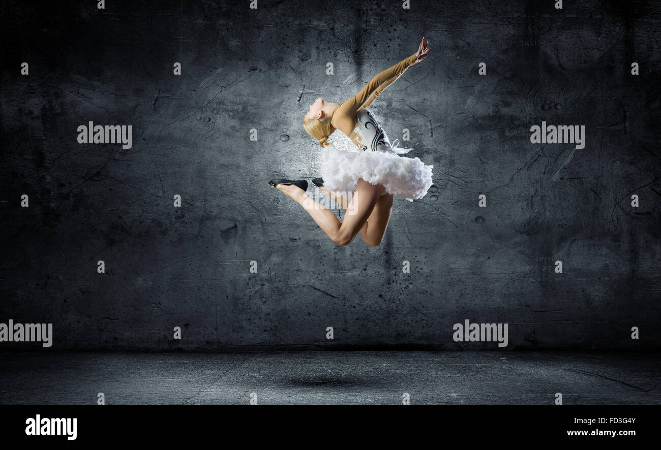 Young pretty ballerina girl making jump in dance Stock Photo - Alamy