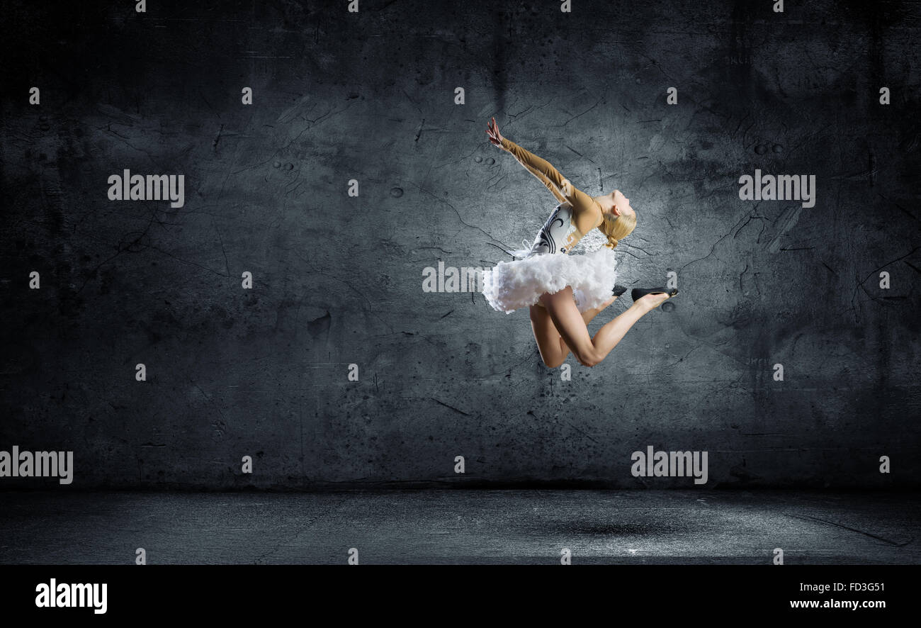 Young pretty ballerina girl making jump in dance Stock Photo - Alamy