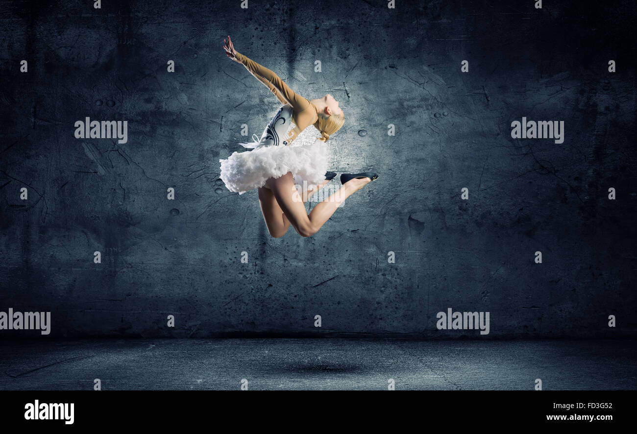 Young pretty ballerina girl making jump in dance Stock Photo - Alamy