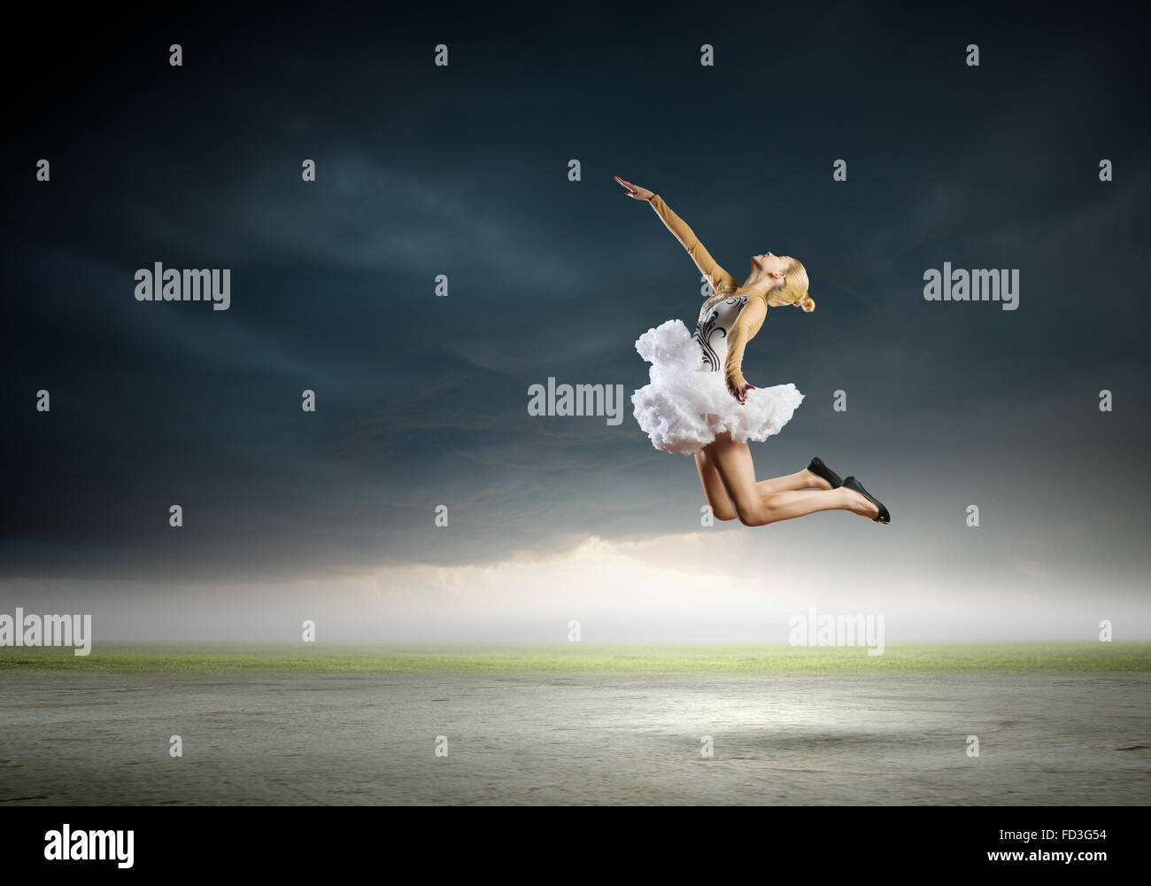 Young pretty ballerina girl making jump in dance Stock Photo - Alamy