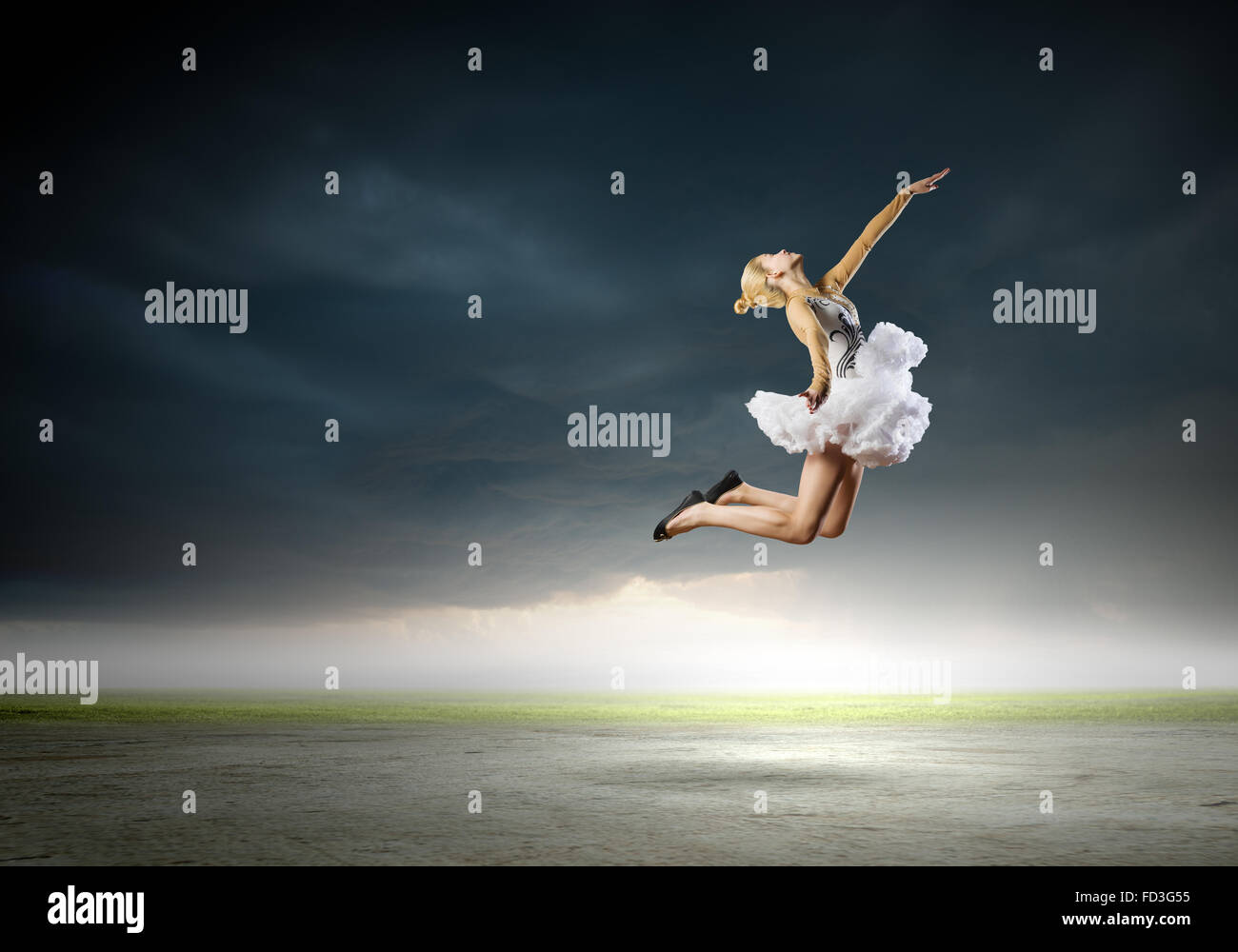 Young pretty ballerina girl making jump in dance Stock Photo - Alamy