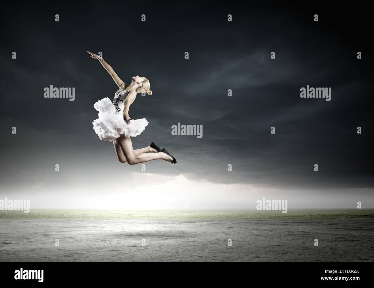 Young pretty ballerina girl making jump in dance Stock Photo - Alamy