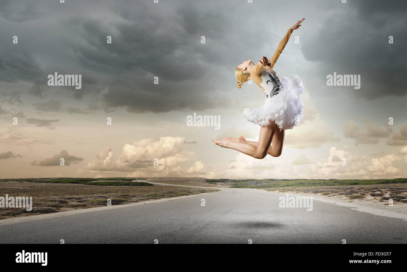 Young pretty ballerina girl making jump in dance Stock Photo - Alamy