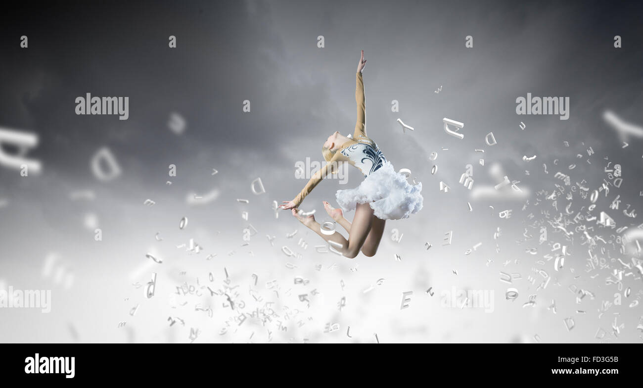 Young pretty ballerina girl making jump in dance Stock Photo - Alamy