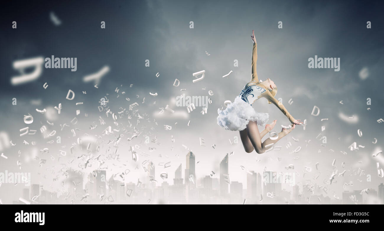 Young pretty ballerina girl making jump in dance Stock Photo - Alamy