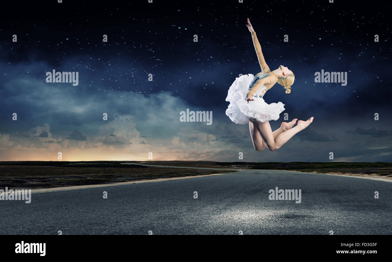 Young pretty ballerina girl making jump in dance Stock Photo - Alamy