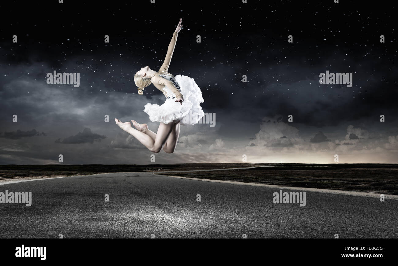 Young pretty ballerina girl making jump in dance Stock Photo - Alamy