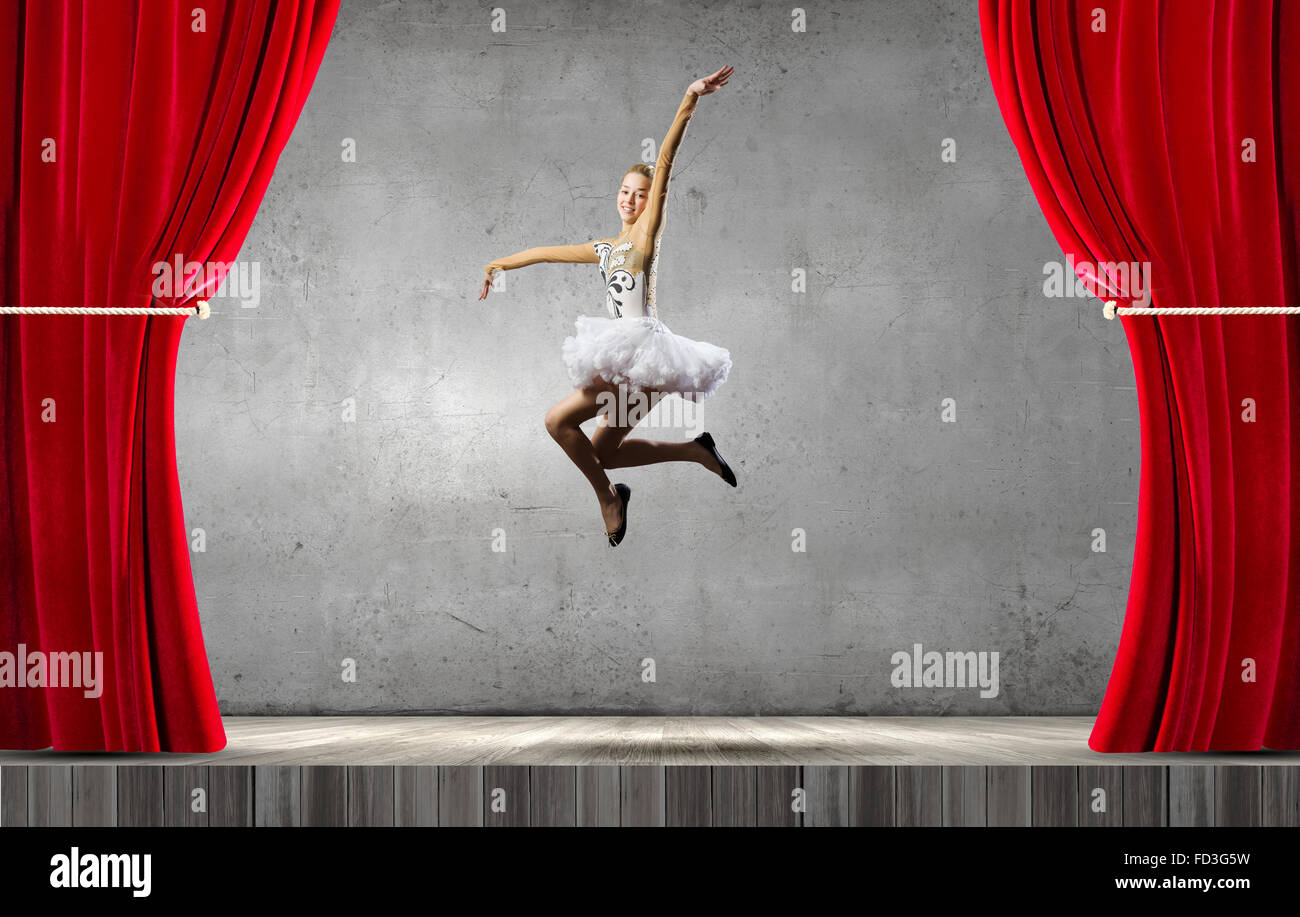 Young pretty ballerina girl making jump in dance Stock Photo - Alamy