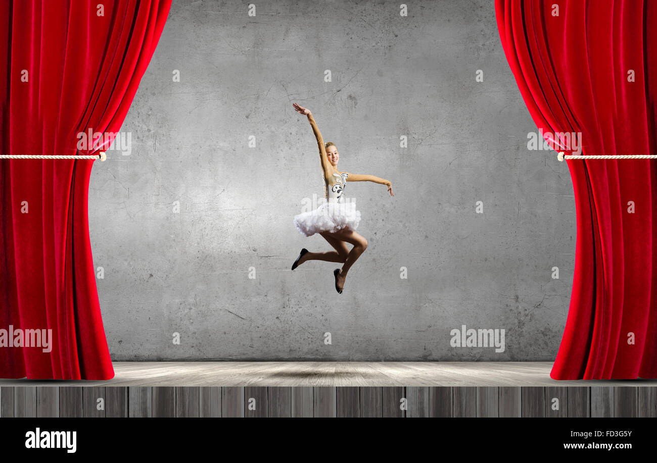 Young pretty ballerina girl making jump in dance Stock Photo - Alamy