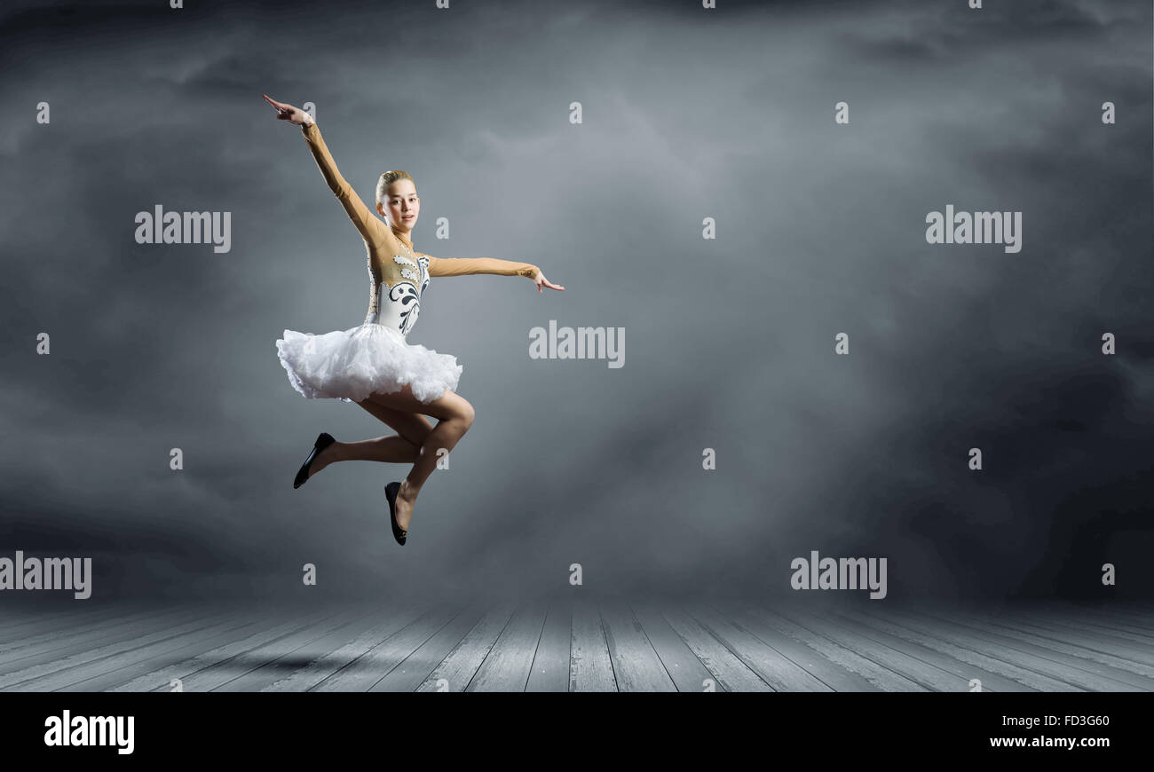 Young pretty ballerina girl making jump in dance Stock Photo - Alamy