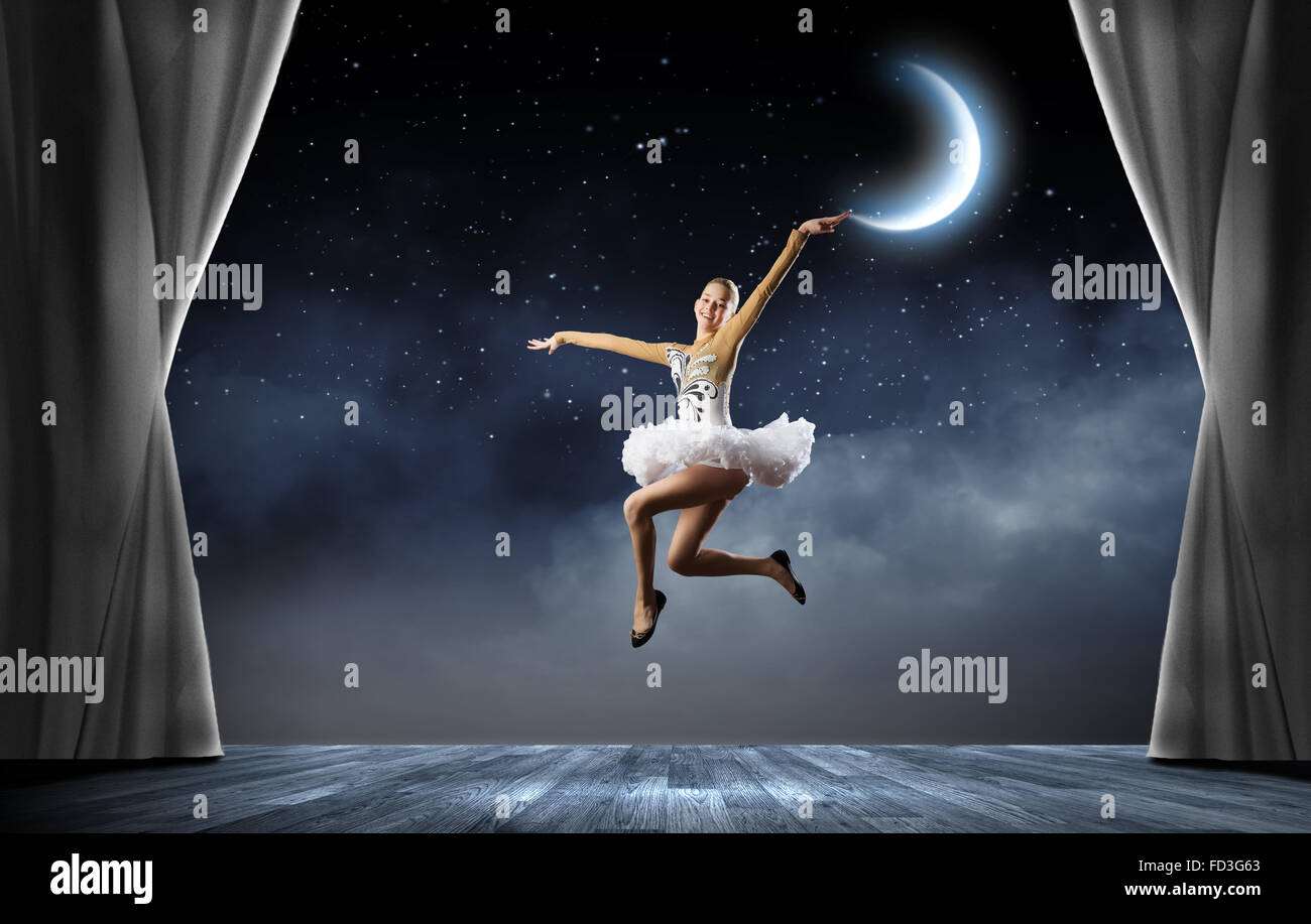 Young pretty ballerina girl making jump in dance Stock Photo - Alamy