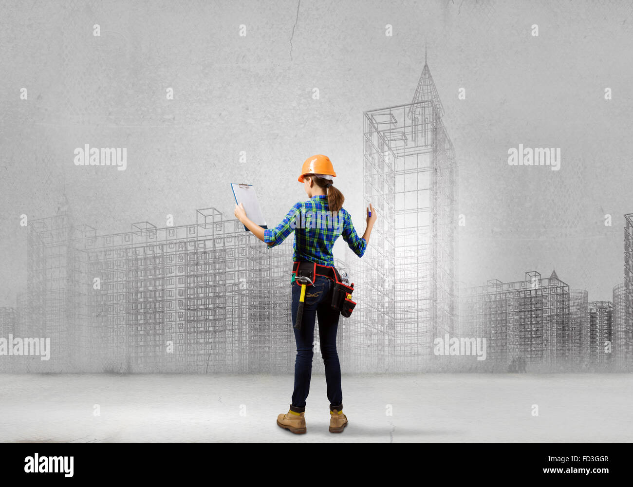 Rear view of woman engineer making some notes and sketches Stock Photo ...