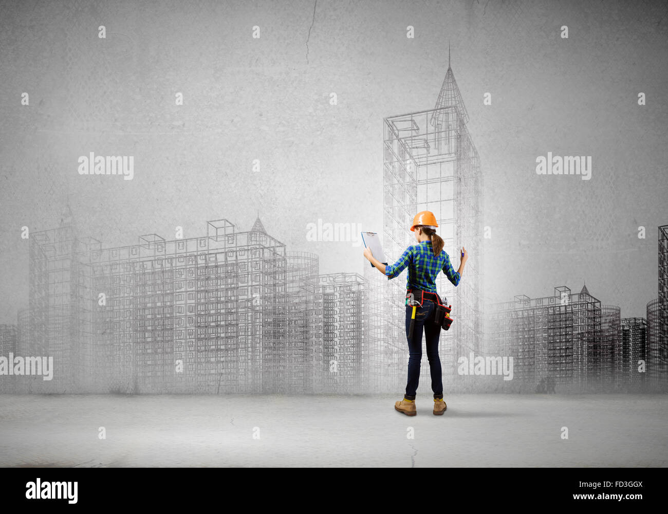 Rear view of woman engineer making some notes and sketches Stock Photo ...