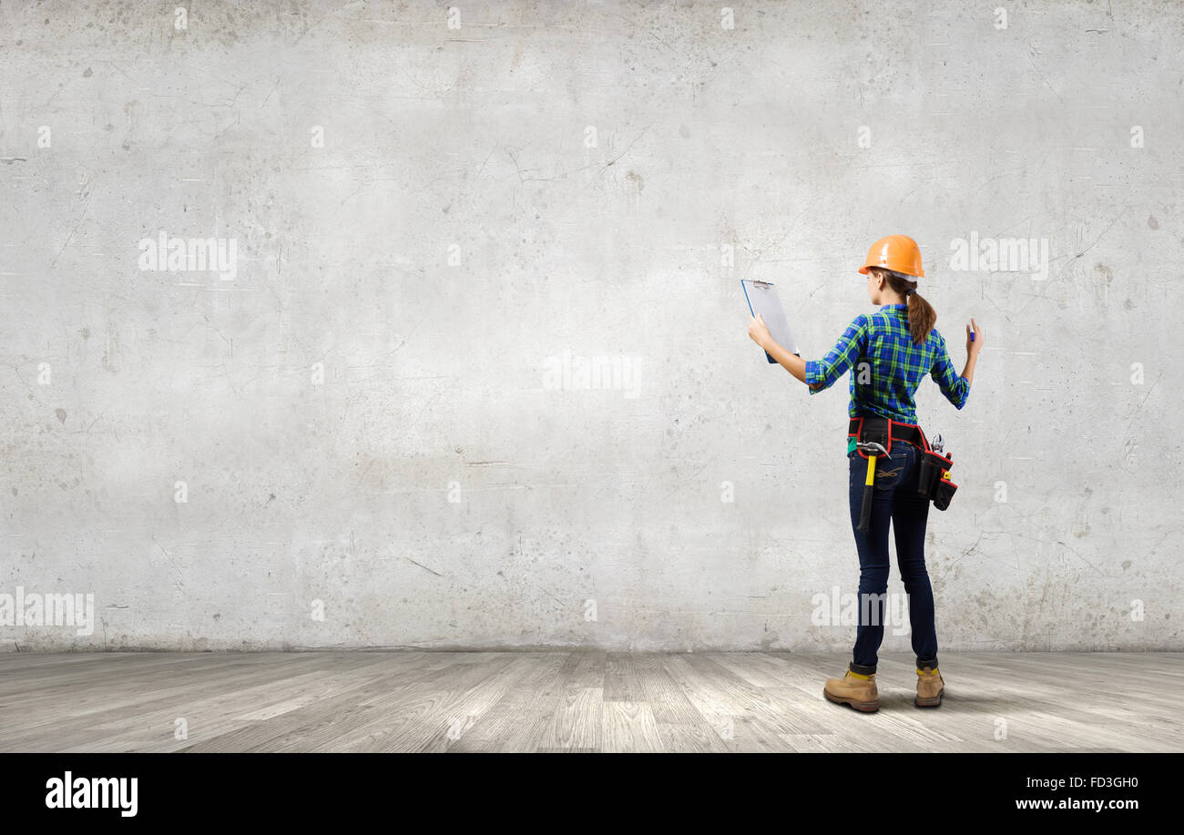 Rear view of woman engineer making some notes and sketches Stock Photo ...