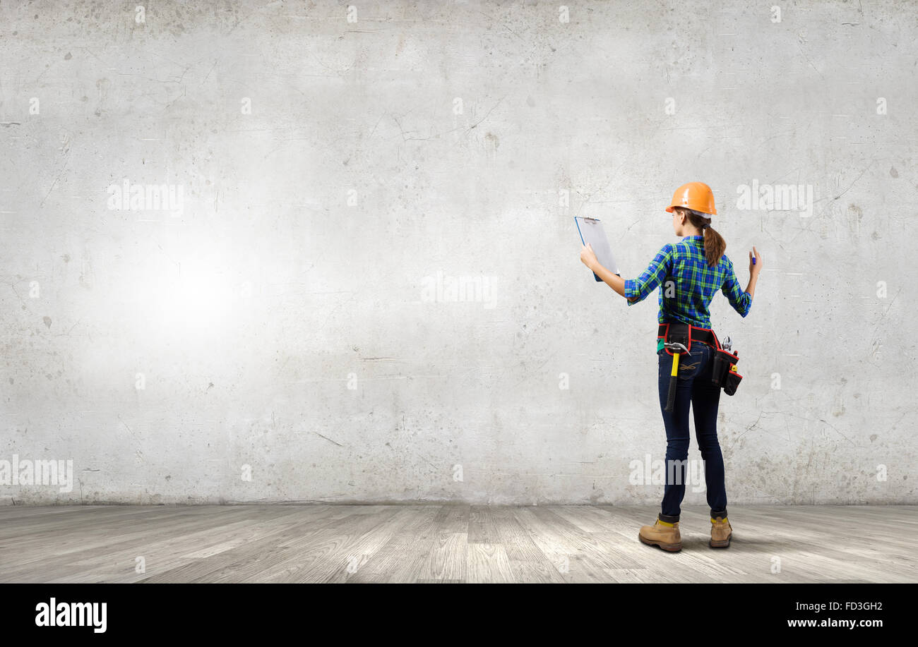 Rear view of woman engineer making some notes and sketches Stock Photo ...