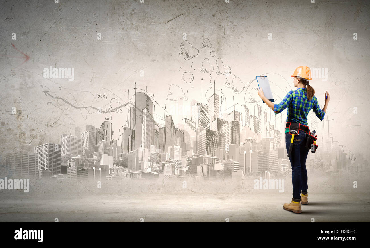 Rear view of woman engineer making some notes and sketches Stock Photo ...