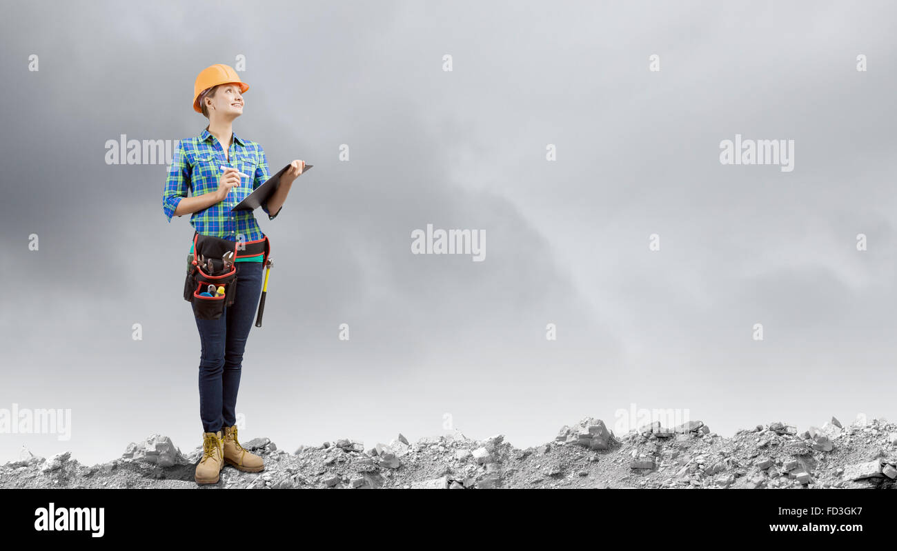 Attractive woman engineer making some notes and sketches Stock Photo ...