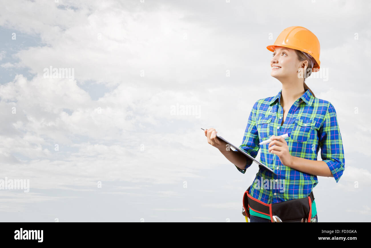 Attractive woman engineer making some notes and sketches Stock Photo ...
