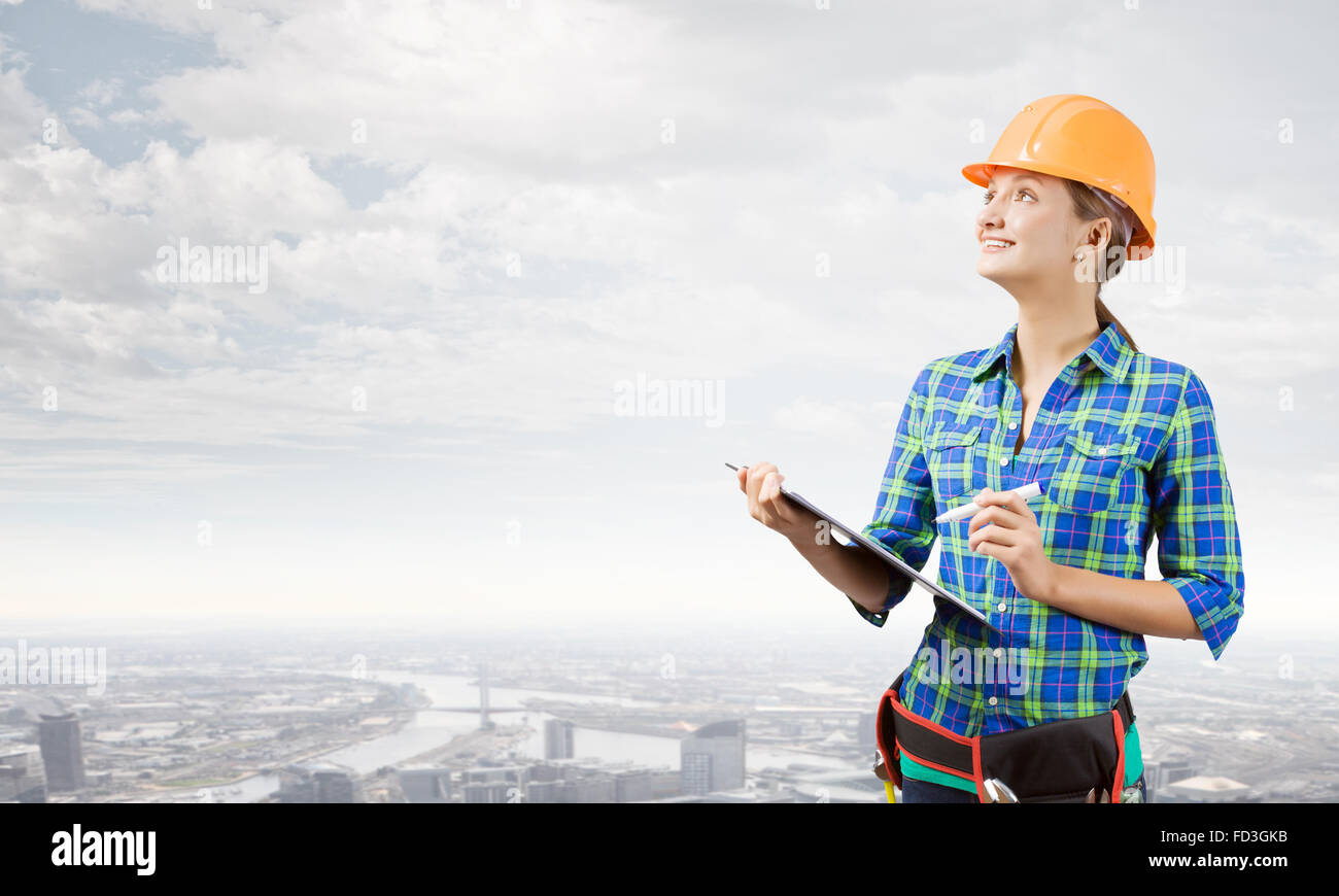 Attractive woman engineer making some notes and sketches Stock Photo ...