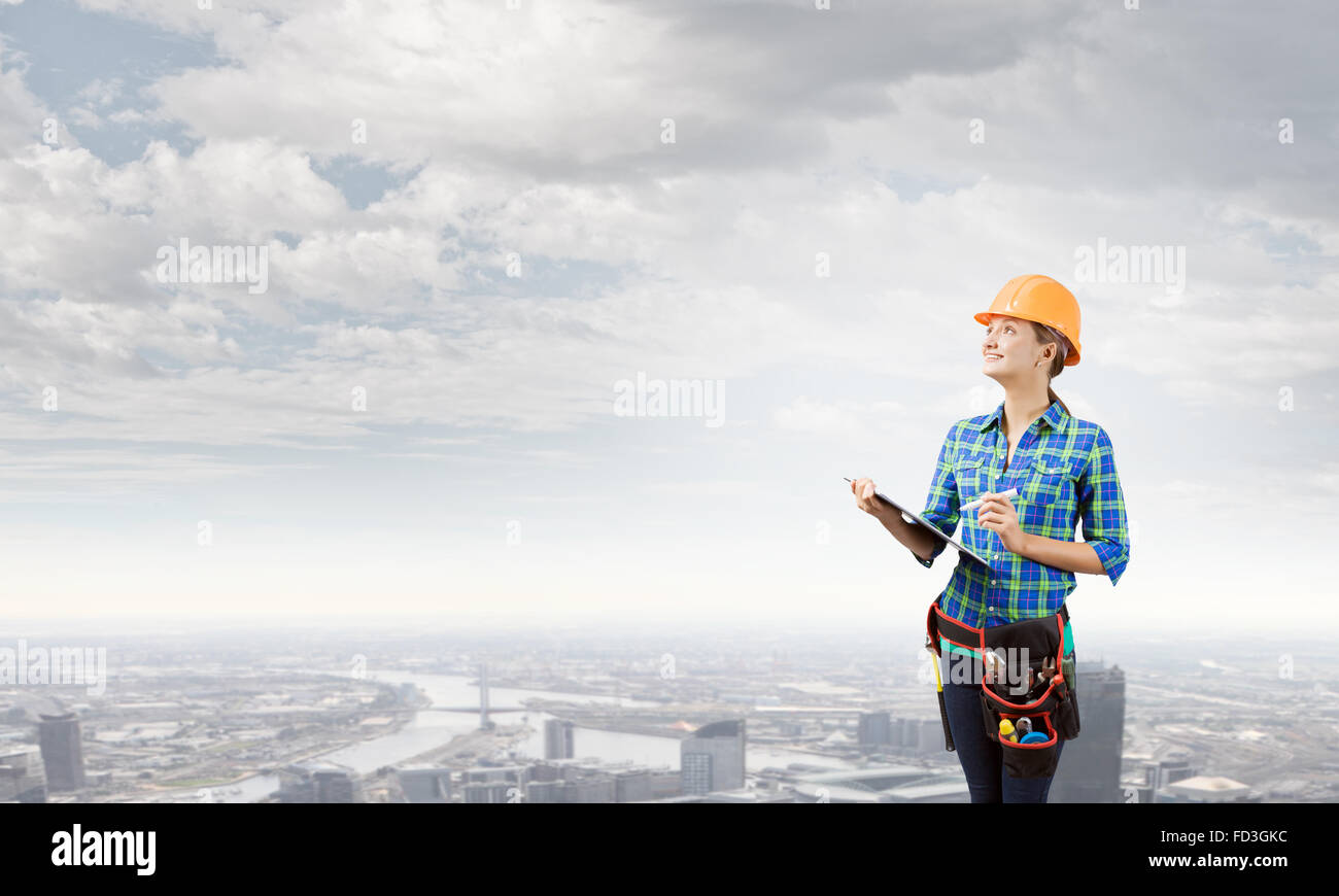 Attractive woman engineer making some notes and sketches Stock Photo ...