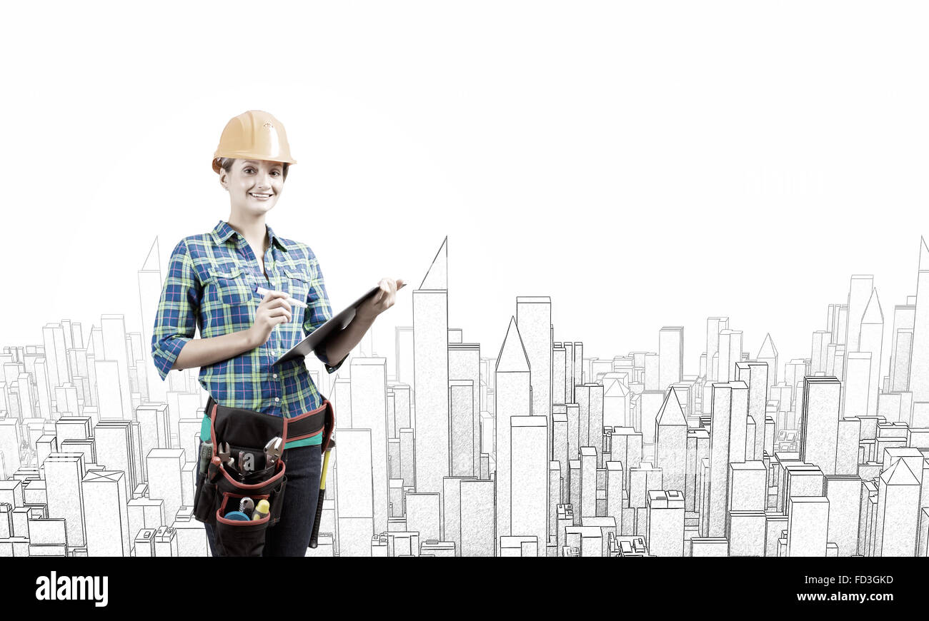 Attractive woman engineer making some notes and sketches Stock Photo ...