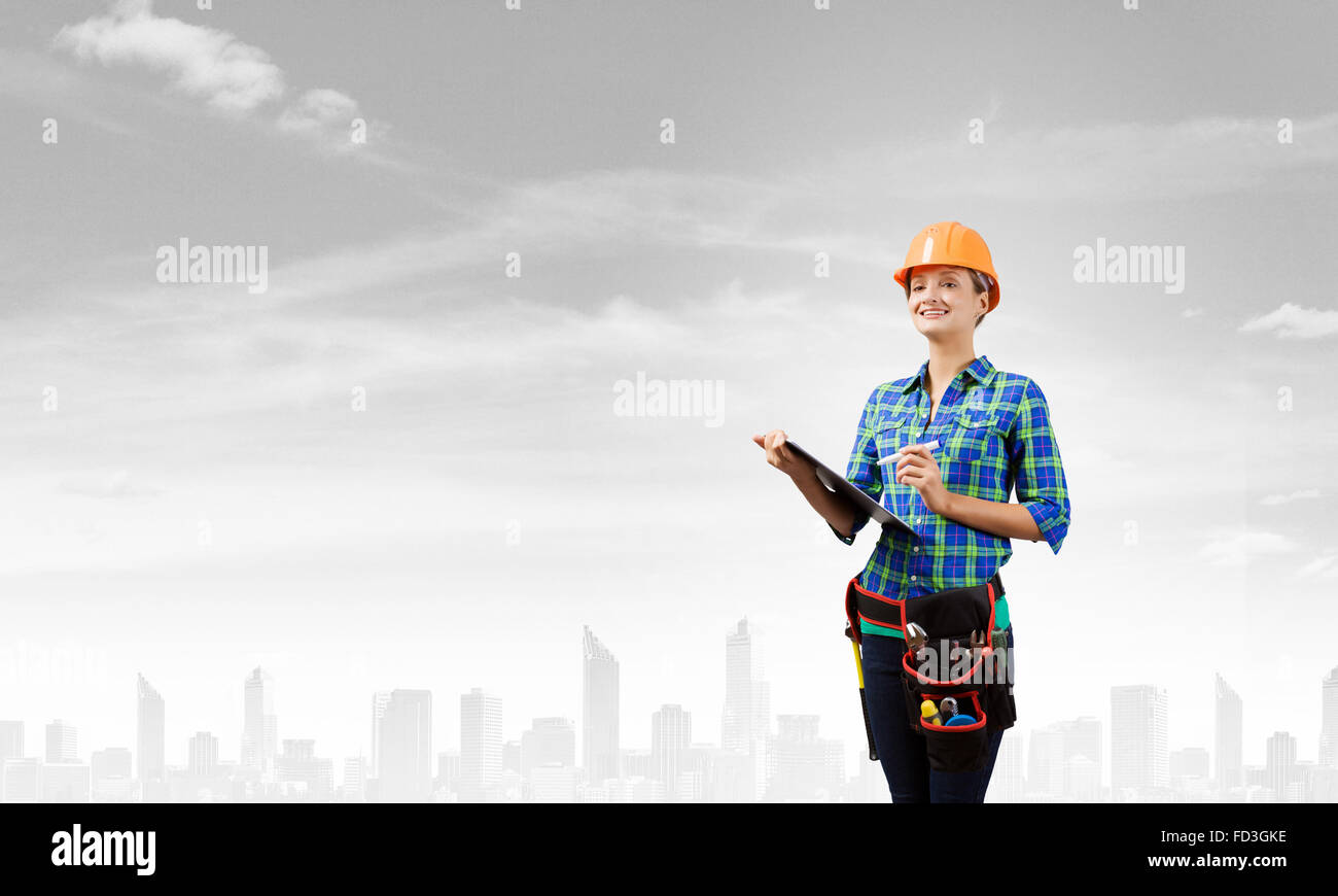 Attractive woman engineer making some notes and sketches Stock Photo ...