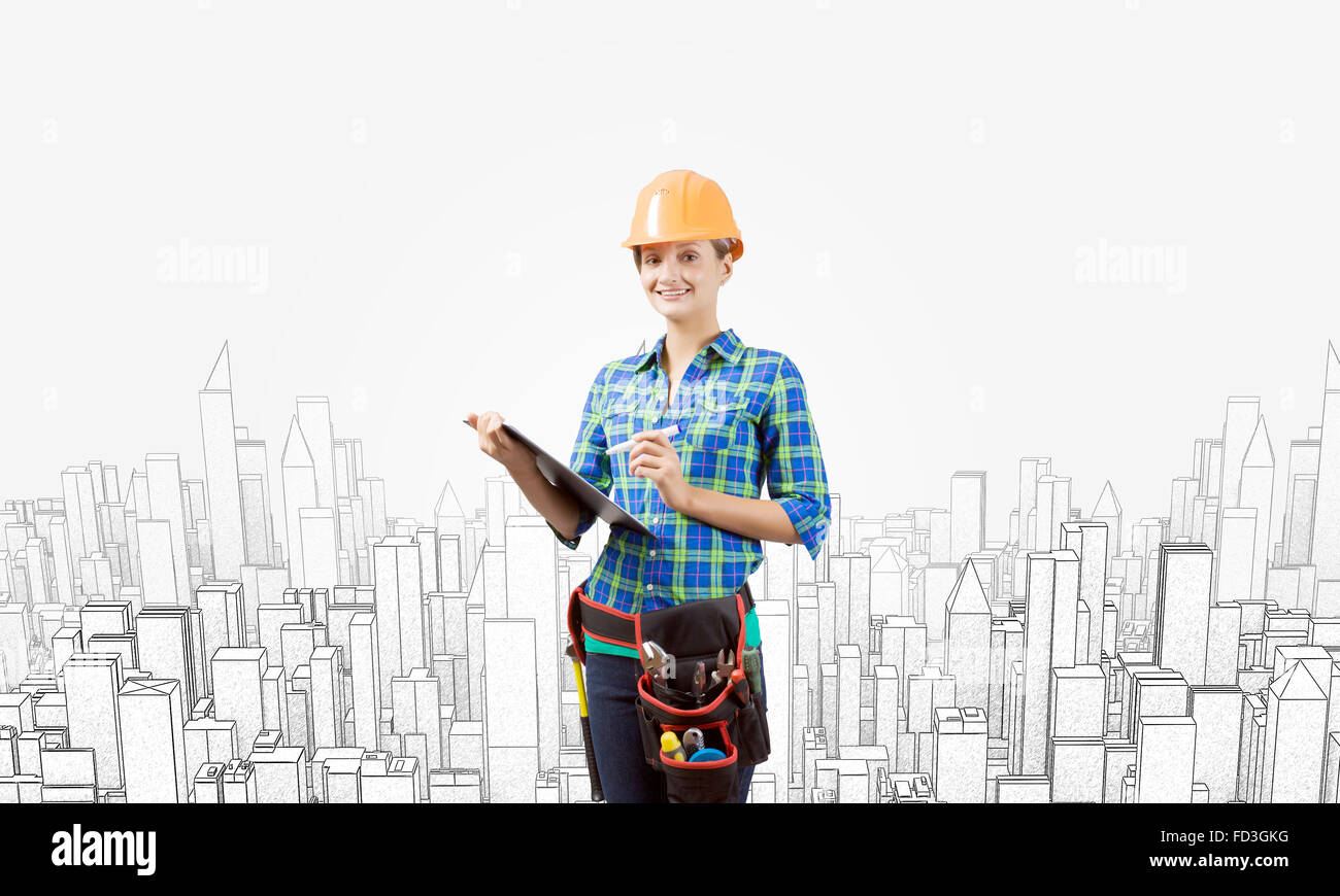 Attractive woman engineer making some notes and sketches Stock Photo ...