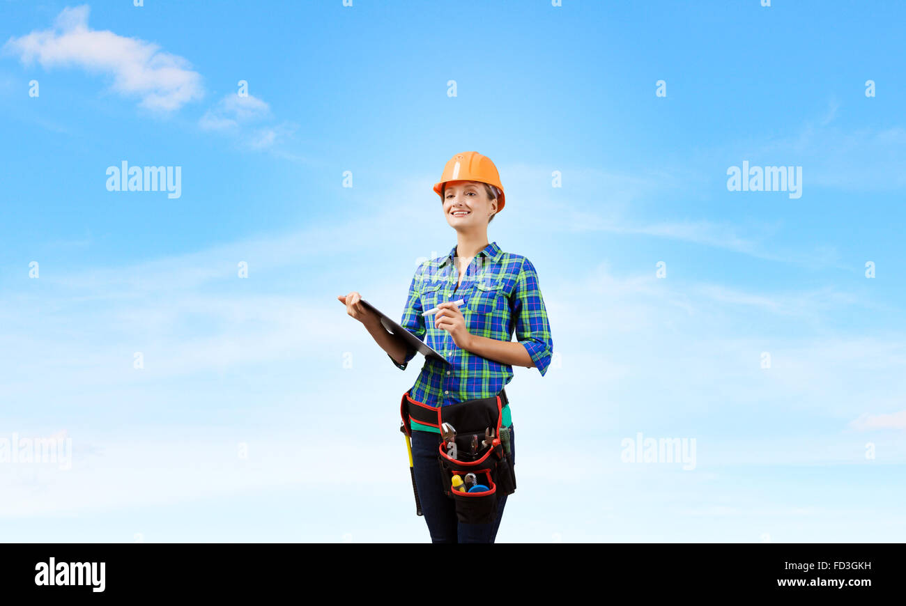 Attractive woman engineer making some notes and sketches Stock Photo ...