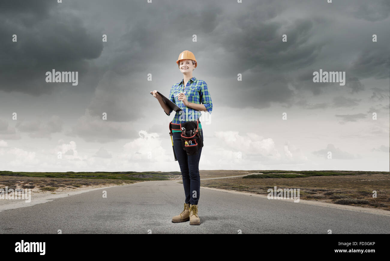 Attractive woman engineer making some notes and sketches Stock Photo ...