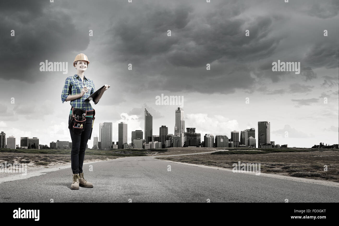 Attractive woman engineer making some notes and sketches Stock Photo ...