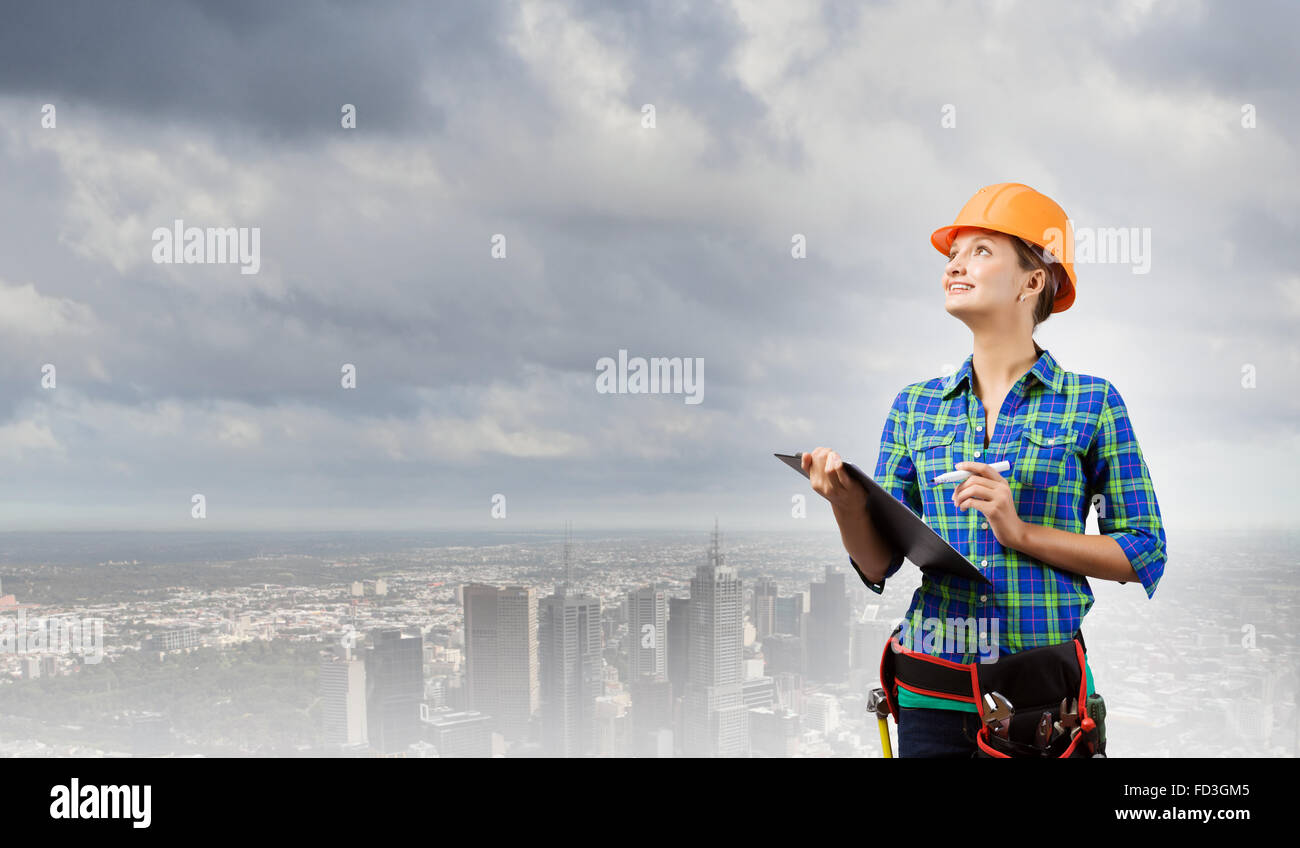 Attractive woman engineer making some notes and sketches Stock Photo ...