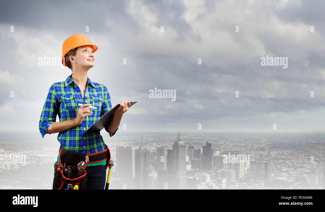 Attractive woman engineer making some notes and sketches Stock Photo ...