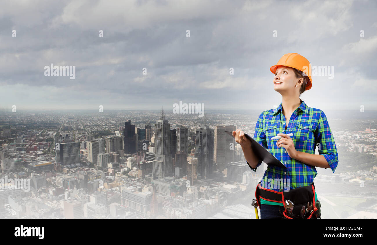 Attractive woman engineer making some notes and sketches Stock Photo ...