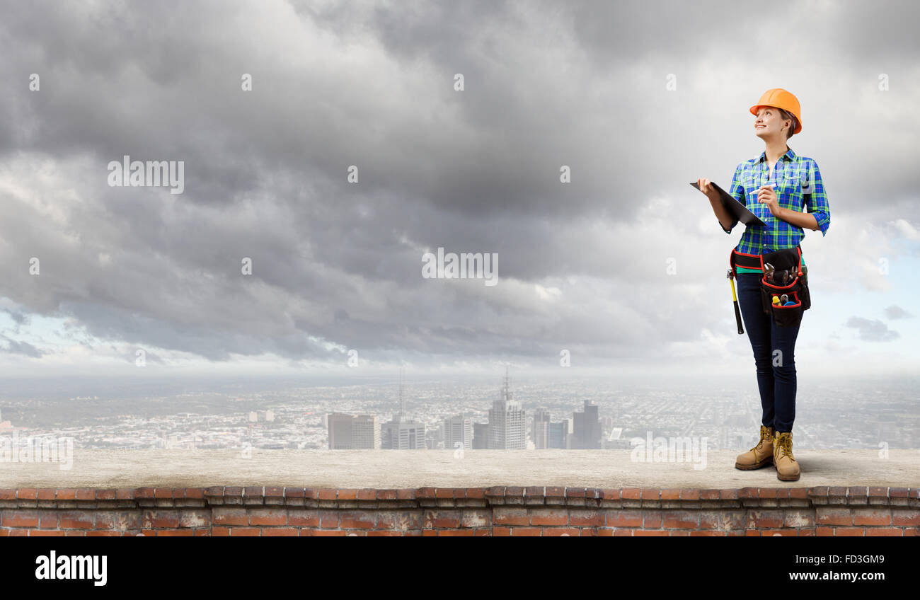 Attractive woman engineer making some notes and sketches Stock Photo ...