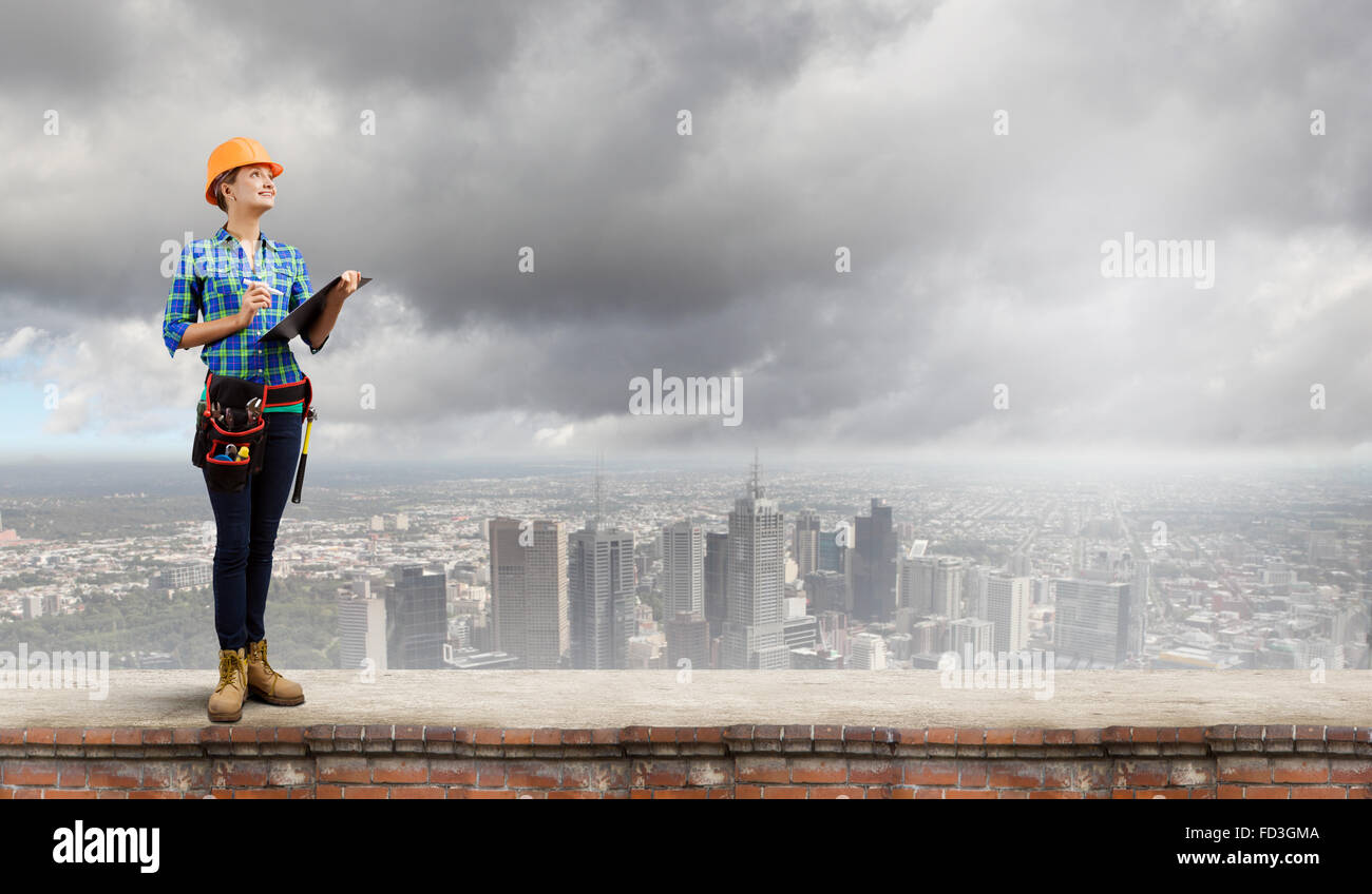 Attractive woman engineer making some notes and sketches Stock Photo ...