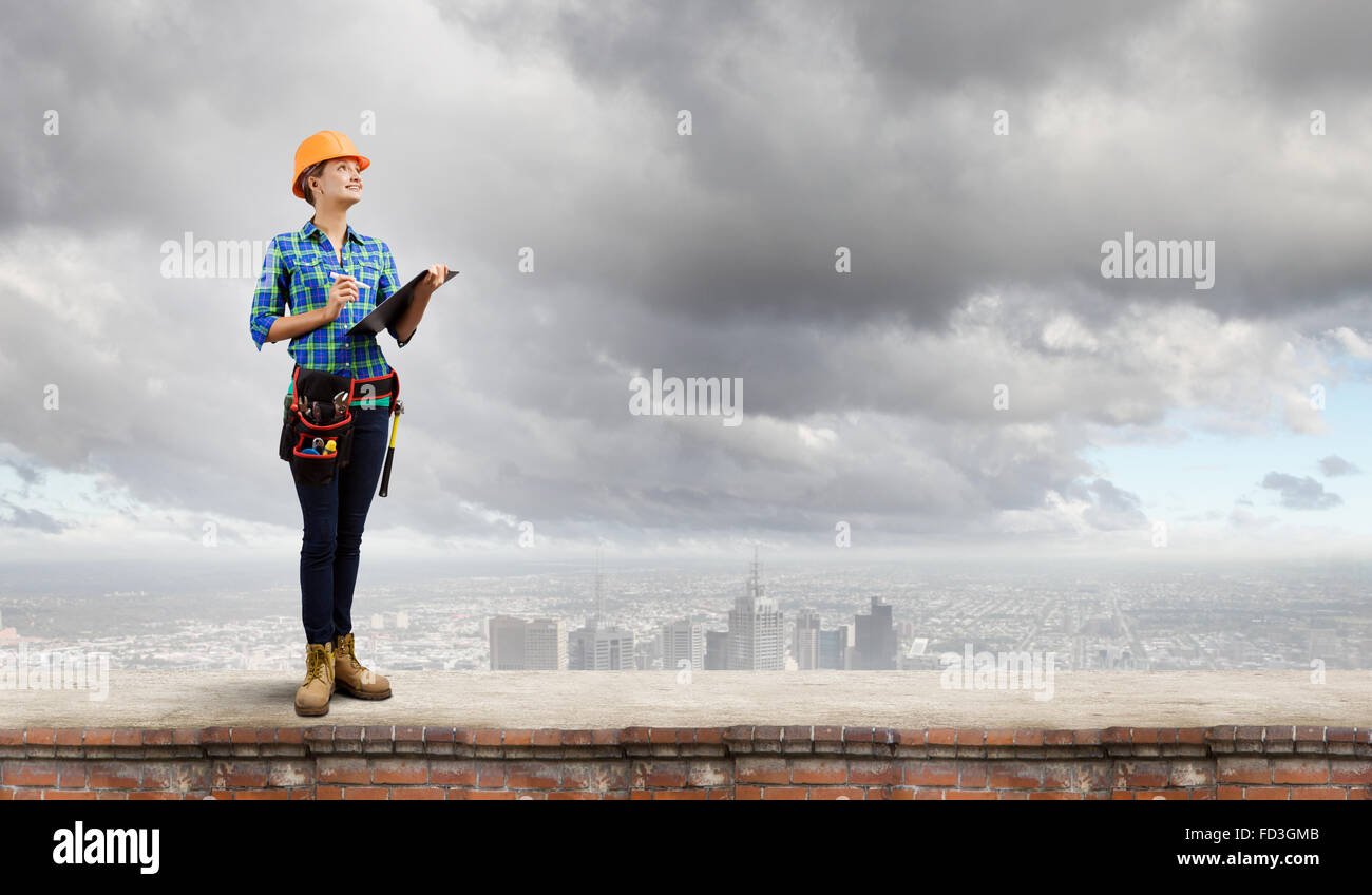 Attractive woman engineer making some notes and sketches Stock Photo ...