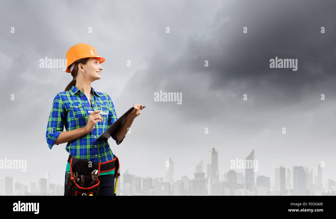 Attractive woman engineer making some notes and sketches Stock Photo ...