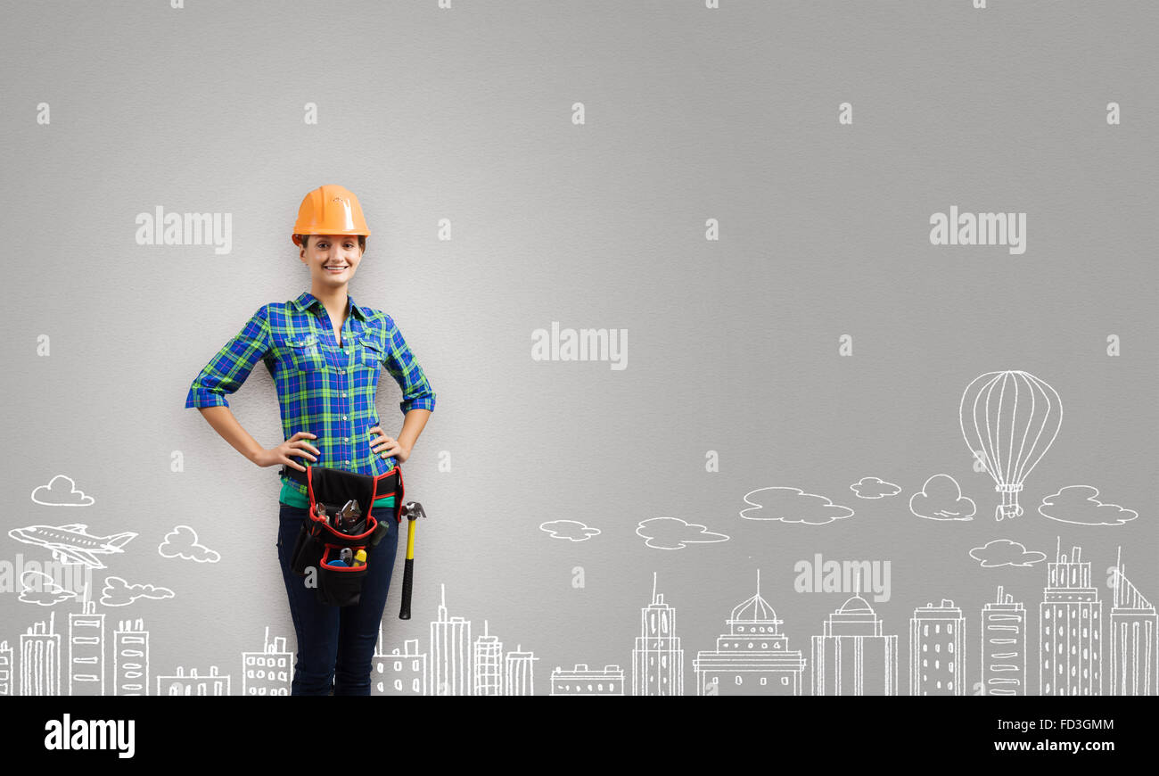 Attractive smiling woman engineer wearing helmet and tool belt Stock ...