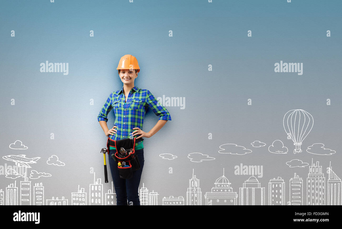 Attractive smiling woman engineer wearing helmet and tool belt Stock ...