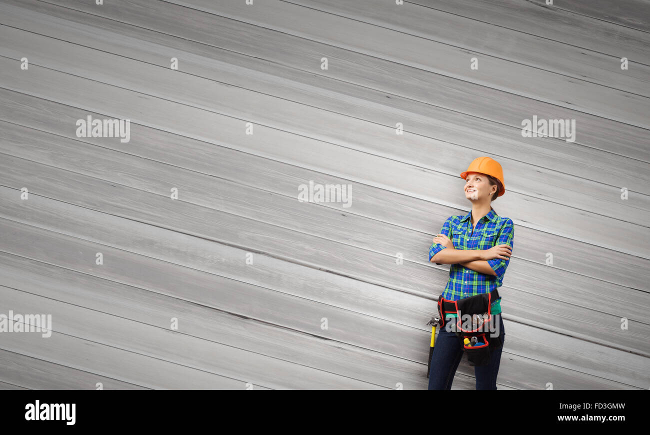 Attractive smiling woman engineer wearing helmet and tool belt Stock ...