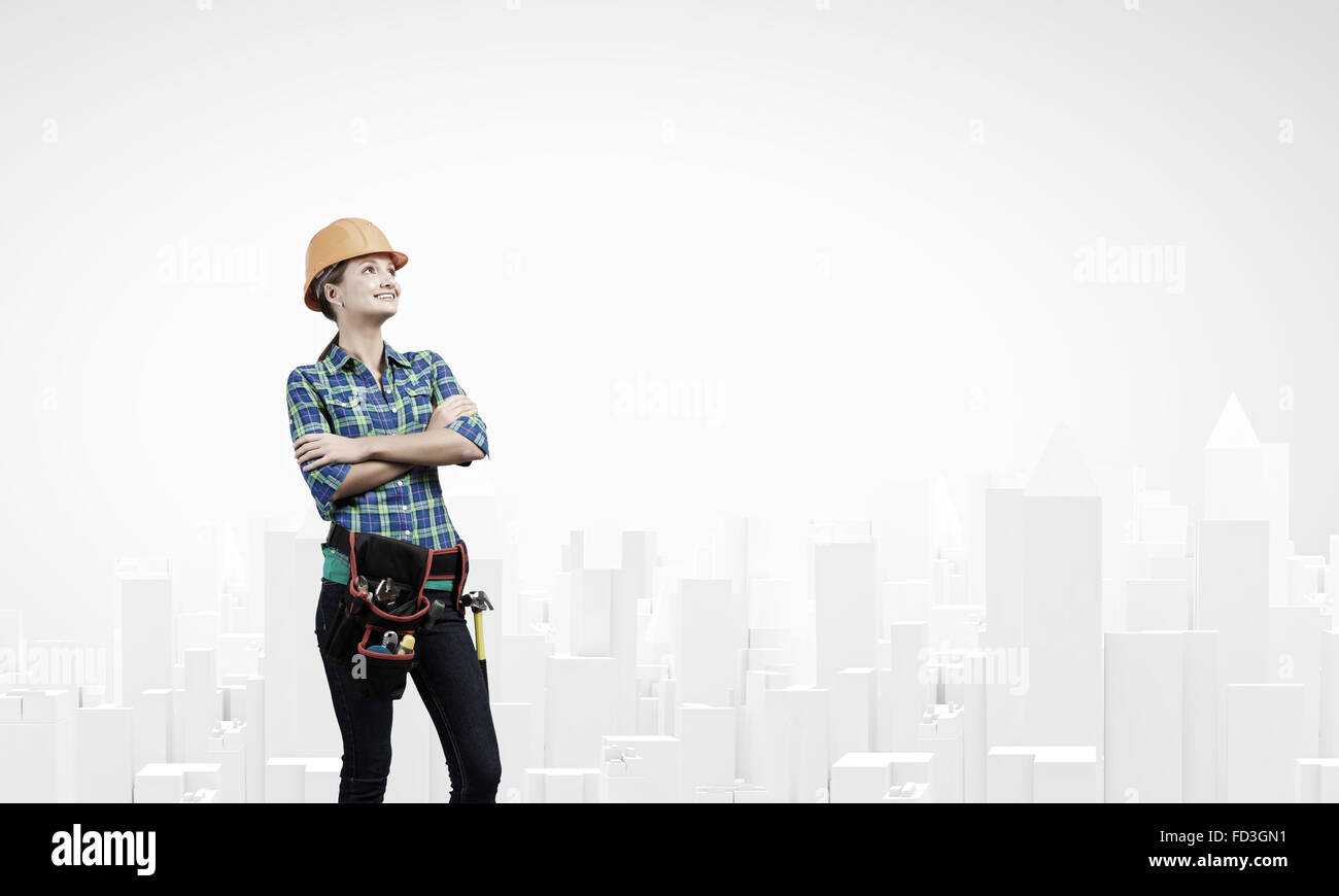 Attractive smiling woman engineer wearing helmet and tool belt Stock ...
