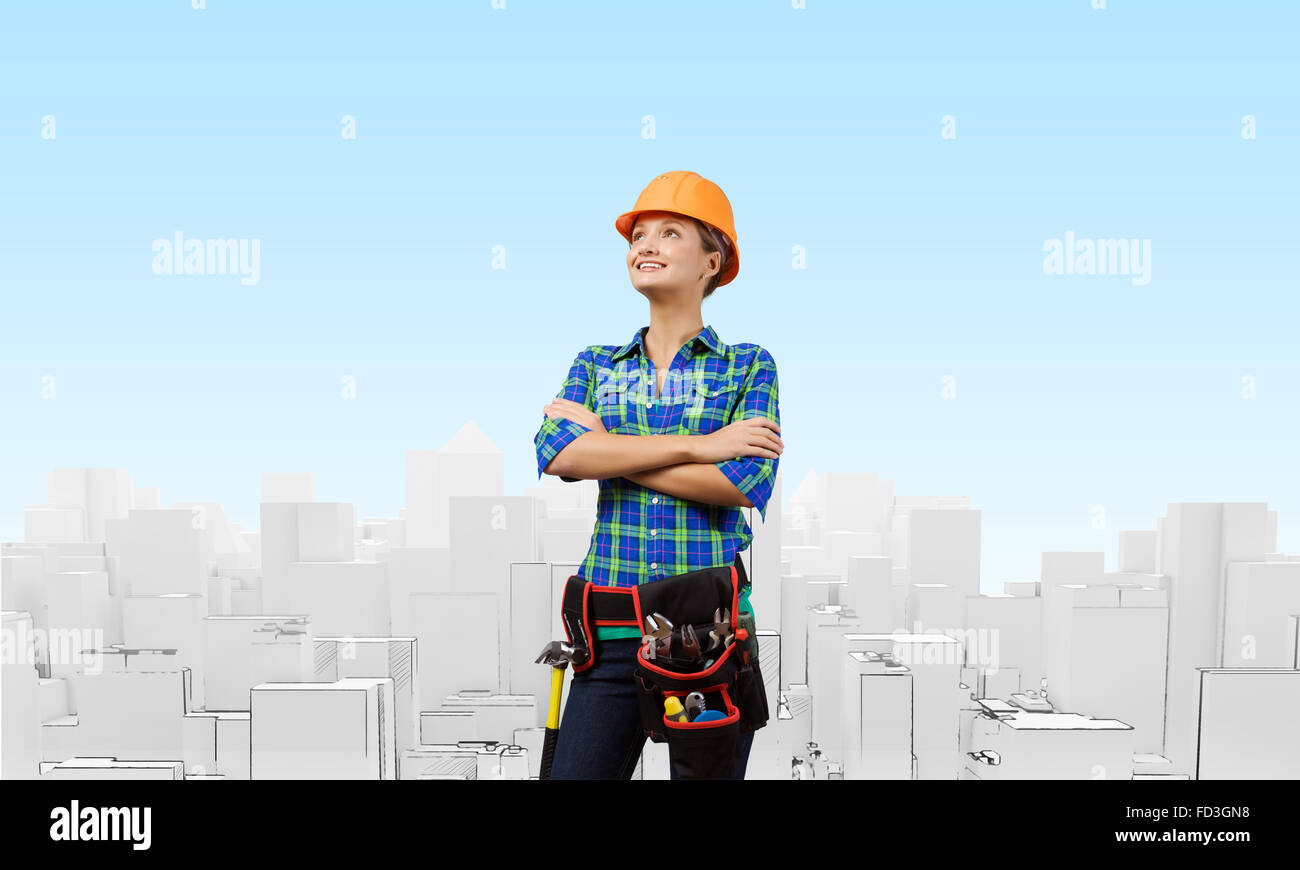 Attractive smiling woman engineer wearing helmet and tool belt Stock ...