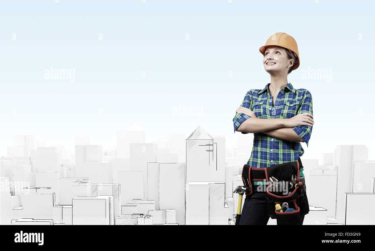 Attractive smiling woman engineer wearing helmet and tool belt Stock ...