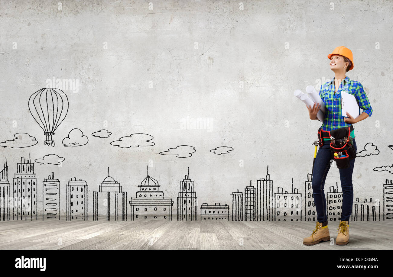 Attractive smiling woman engineer wearing helmet and tool belt Stock ...