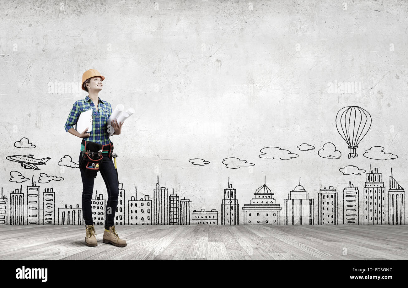 Attractive smiling woman engineer wearing helmet and tool belt Stock ...