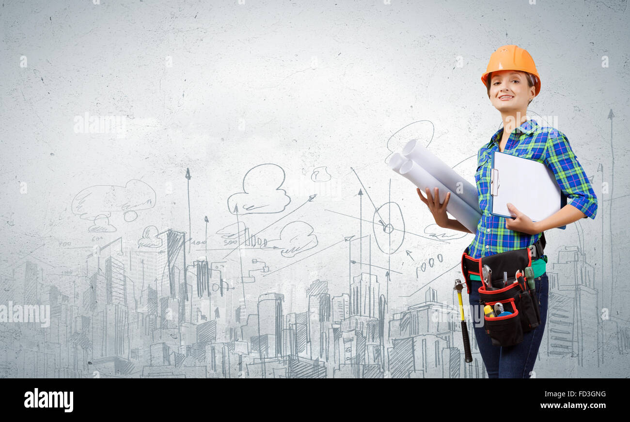 Attractive smiling woman engineer wearing helmet and tool belt Stock ...