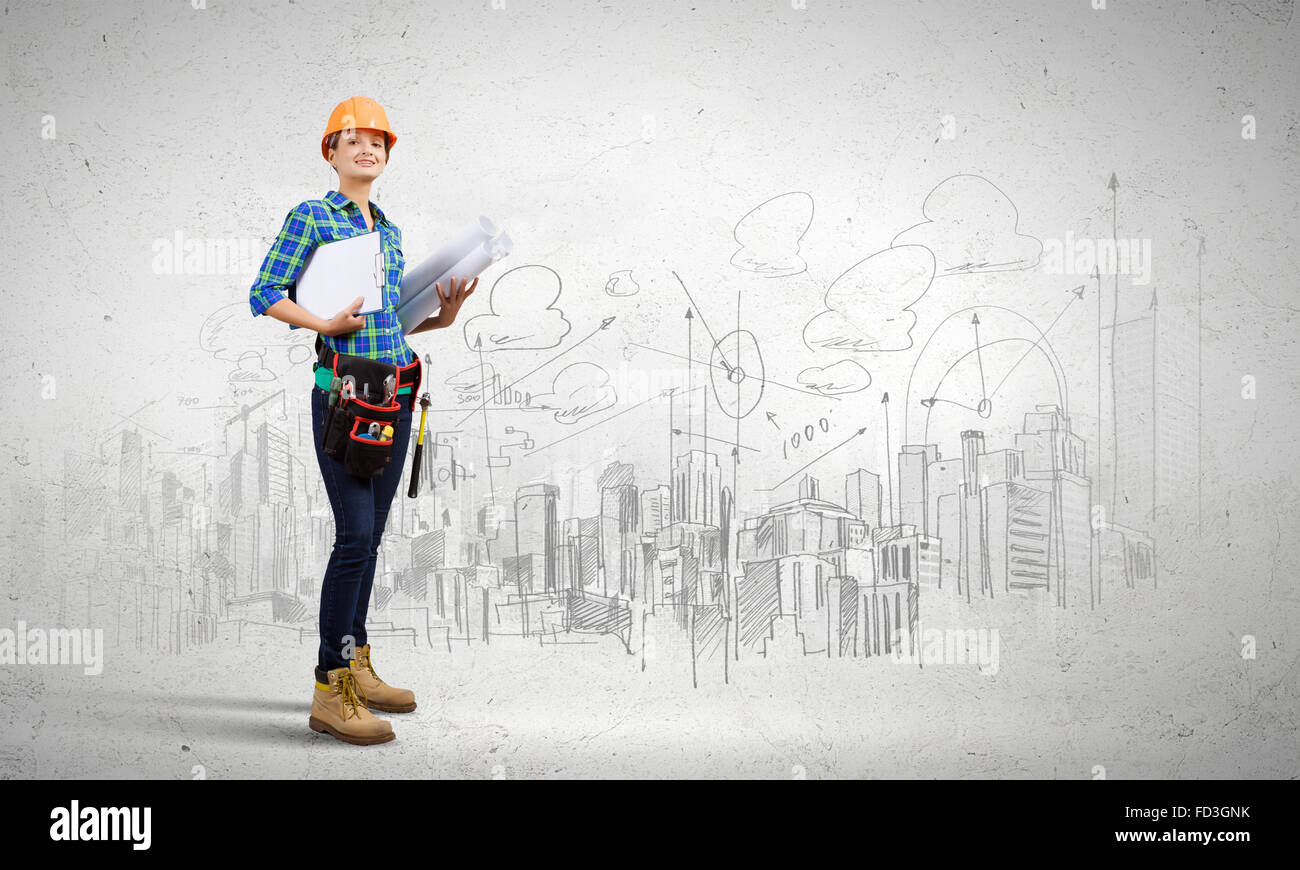 Attractive smiling woman engineer wearing helmet and tool belt Stock ...