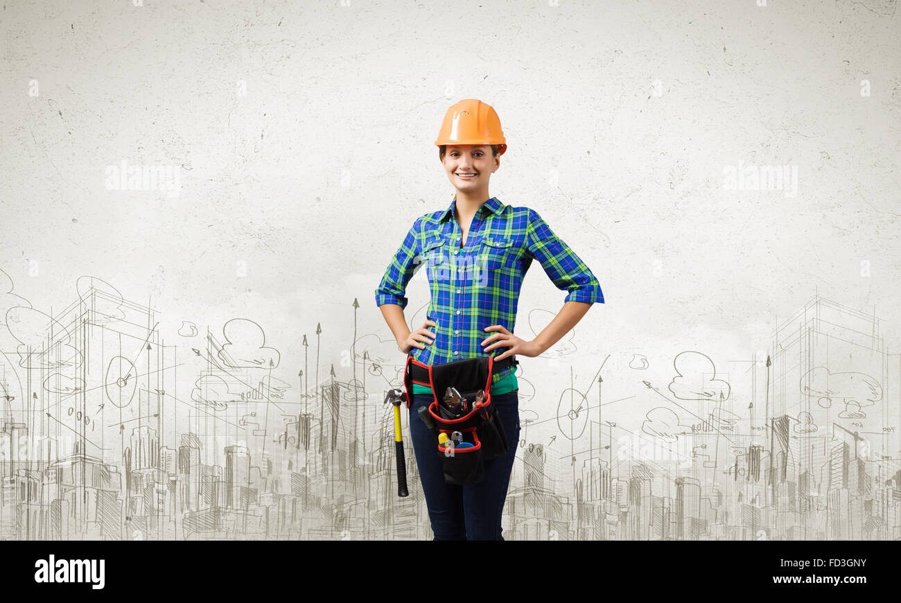 Attractive smiling woman engineer wearing helmet and tool belt Stock ...