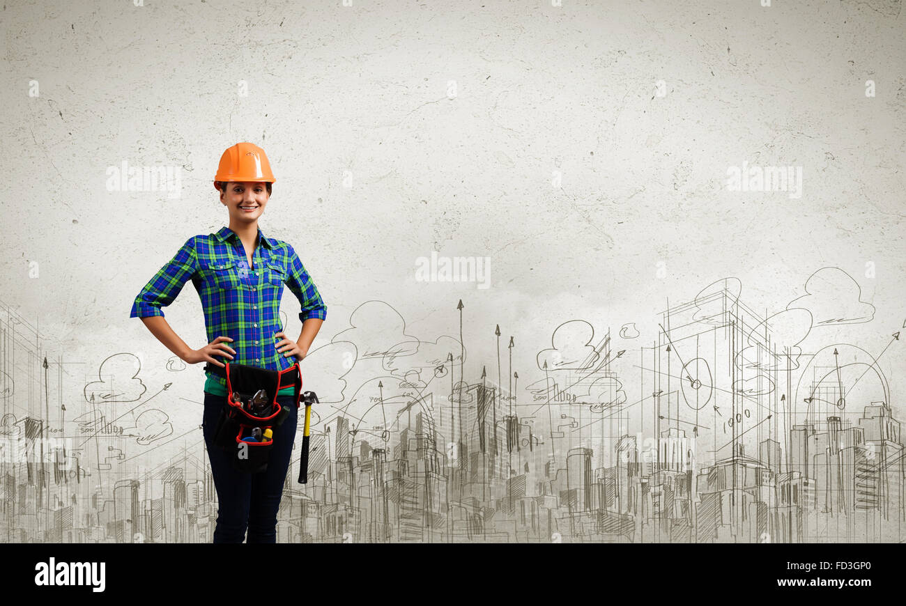 Attractive smiling woman engineer wearing helmet and tool belt Stock ...